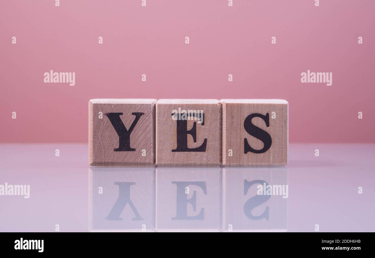 Text YES on wood cube blocks. The letters YES written on the cubes in ...