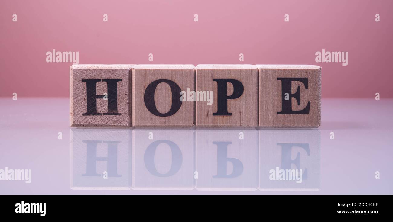 Text HOPE on wood cube blocks. The letters HOPE written on the cubes in ...