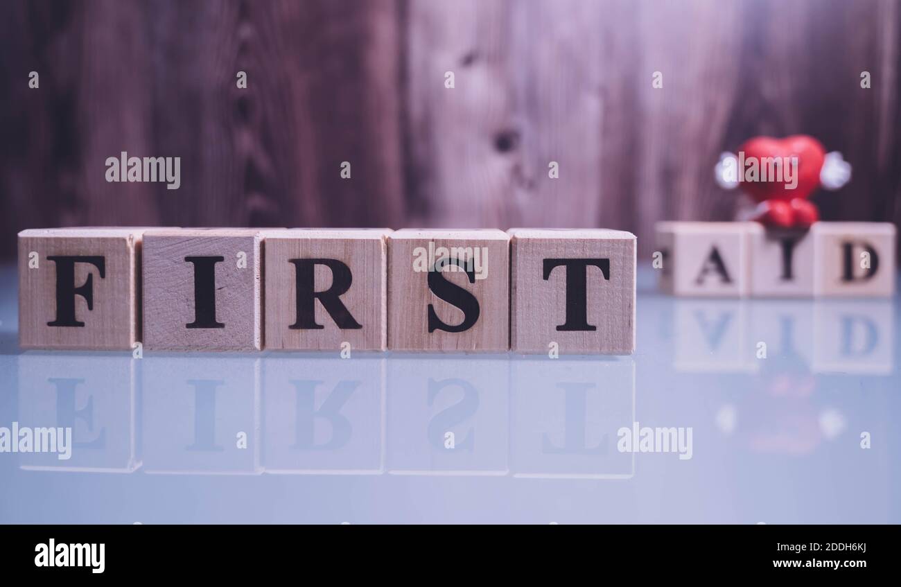 Text FIRST AID on wood cube blocks. The letters FIRST AID written on ...