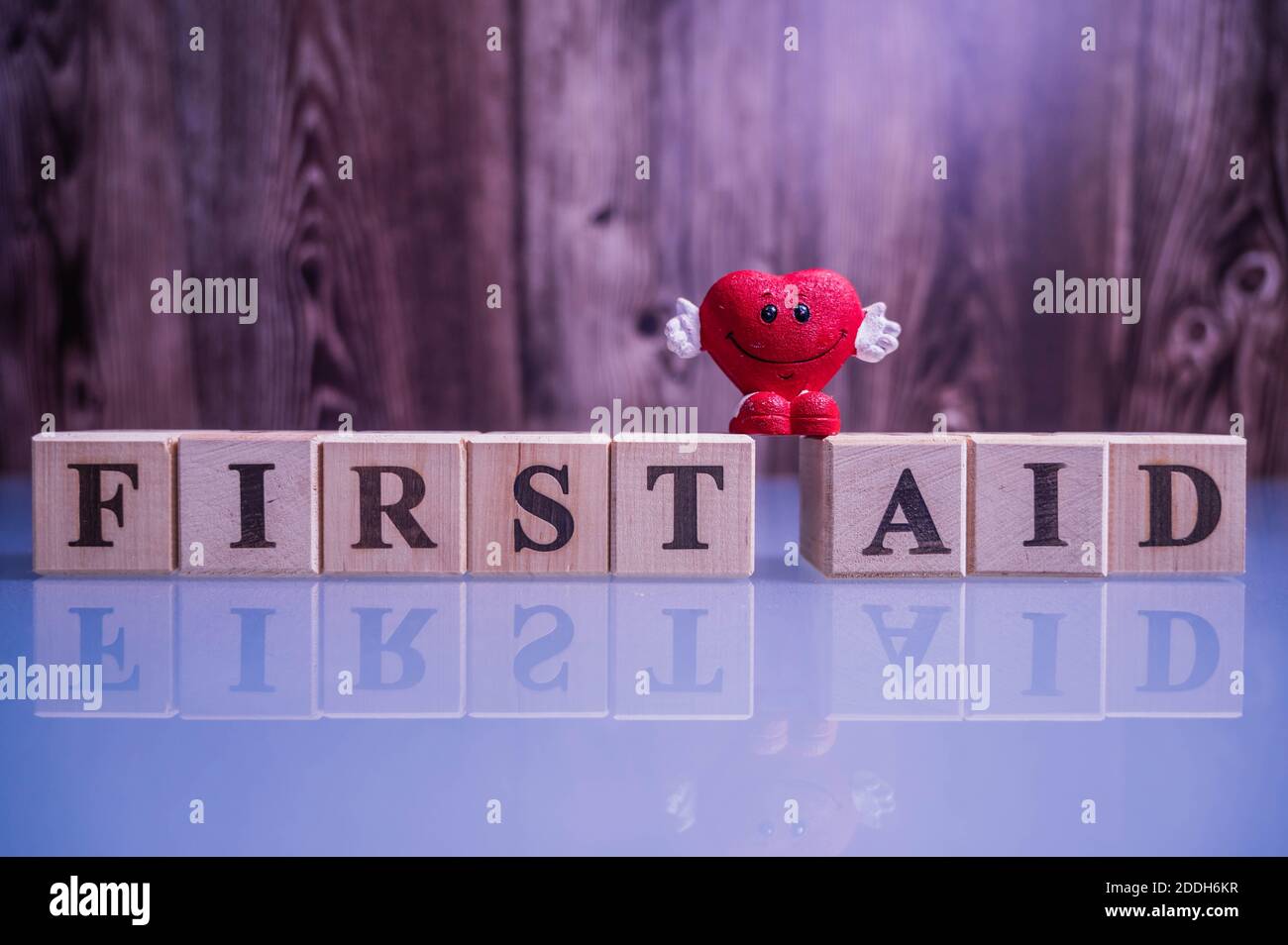 Text FIRST AID on wood cube blocks. The letters FIRST AID written on ...