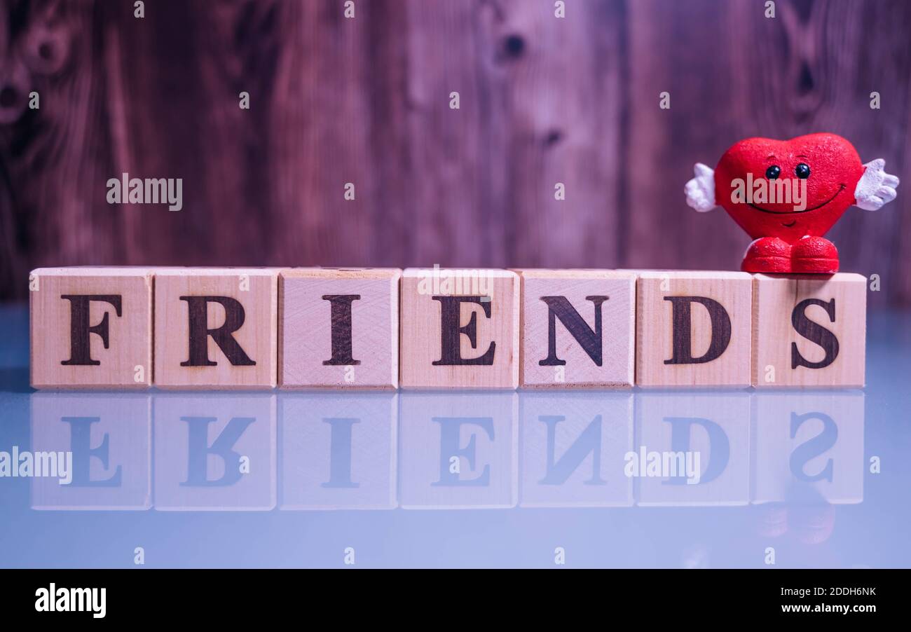 Text FRIENDS on wood cube blocks. The letters FRIENDS written on the ...