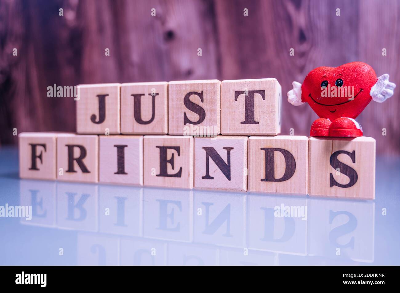 Text JUST FRIENDS on wood cube blocks. The letters JUST FRIENDS written ...