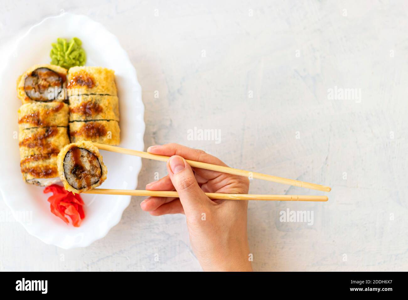Japanese sushi food on white background with copy space. Female hand ...