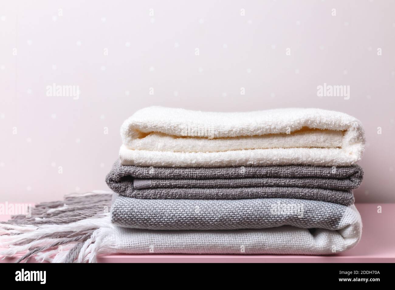 A stack of folded textiles - blankets and towels on the background ...