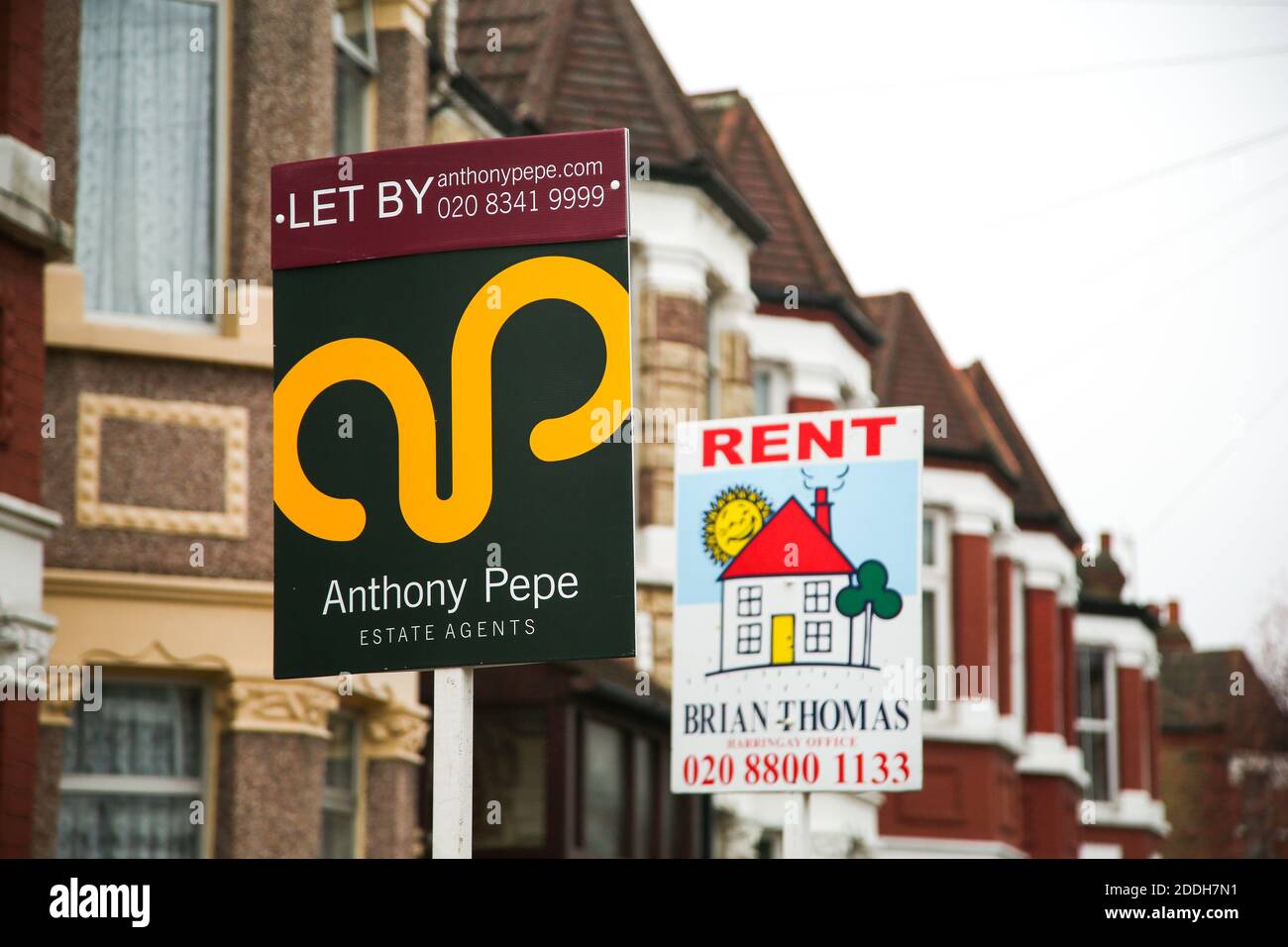 A 'To Let' and "Rent" estate agent board sign erected outside a ...