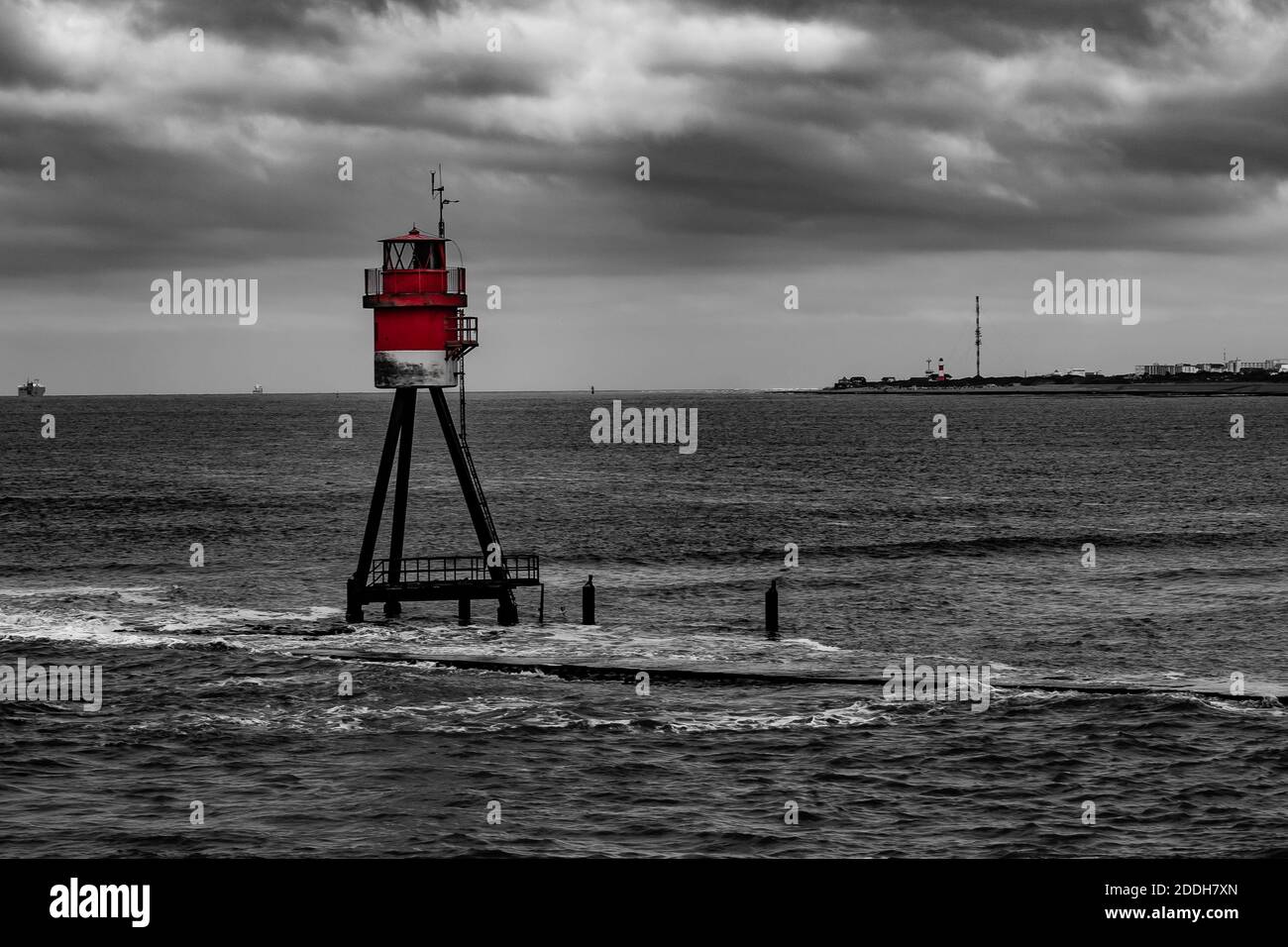 A view of a watchtower at the sea under the cloudy sky in Borkum ...