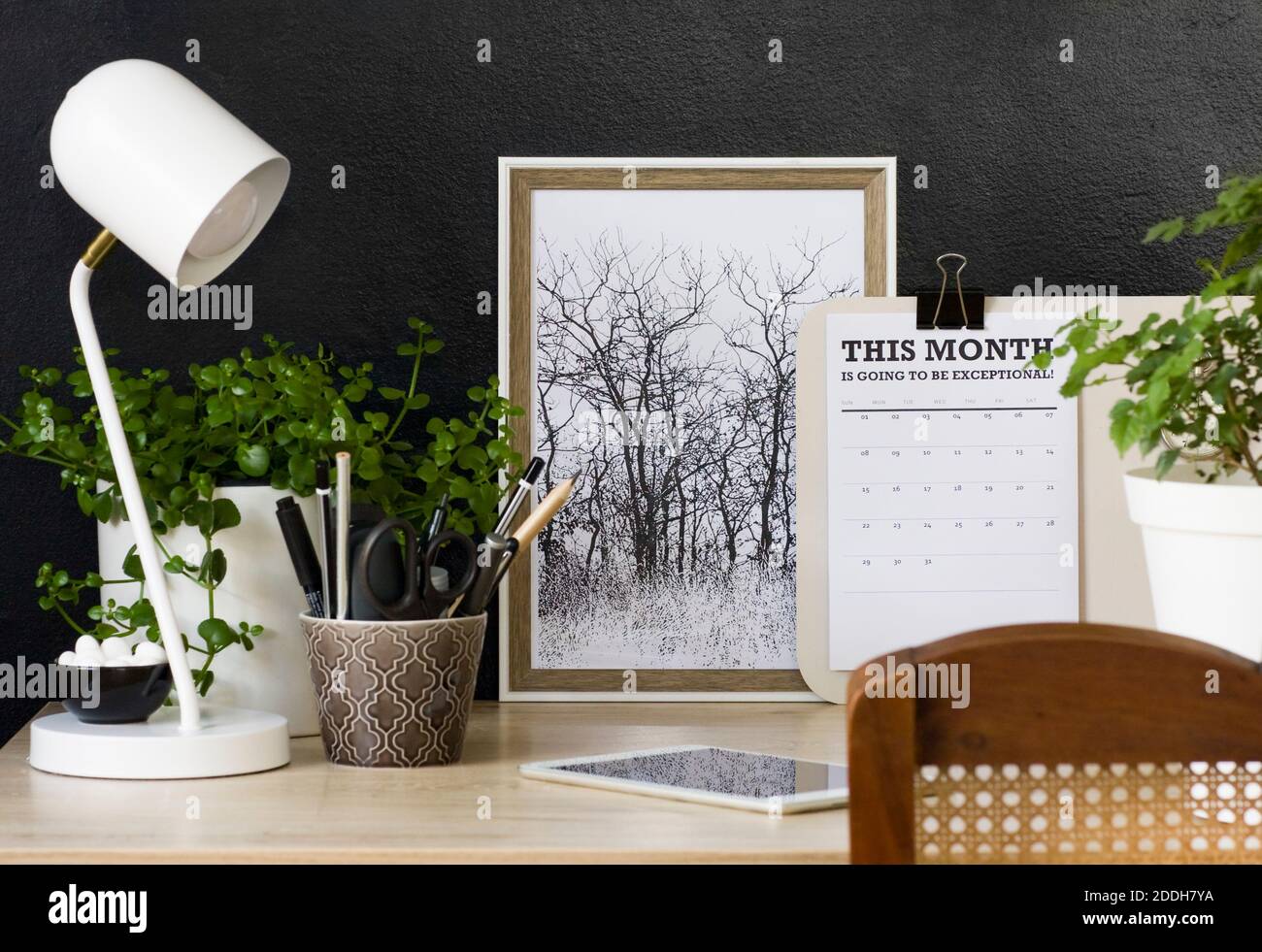 A quiet home office desk equipped with the necessary stationary to work ...