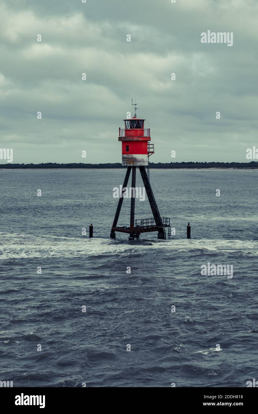 A beautiful view of a watchtower at the sea under the cloudy sky in ...