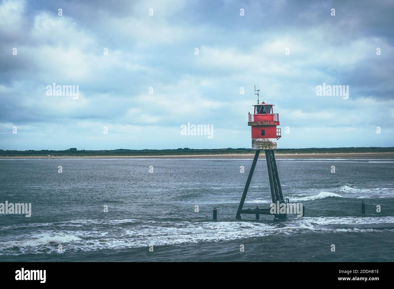 A view of a watchtower at the sea under the cloudy sky in Borkum ...