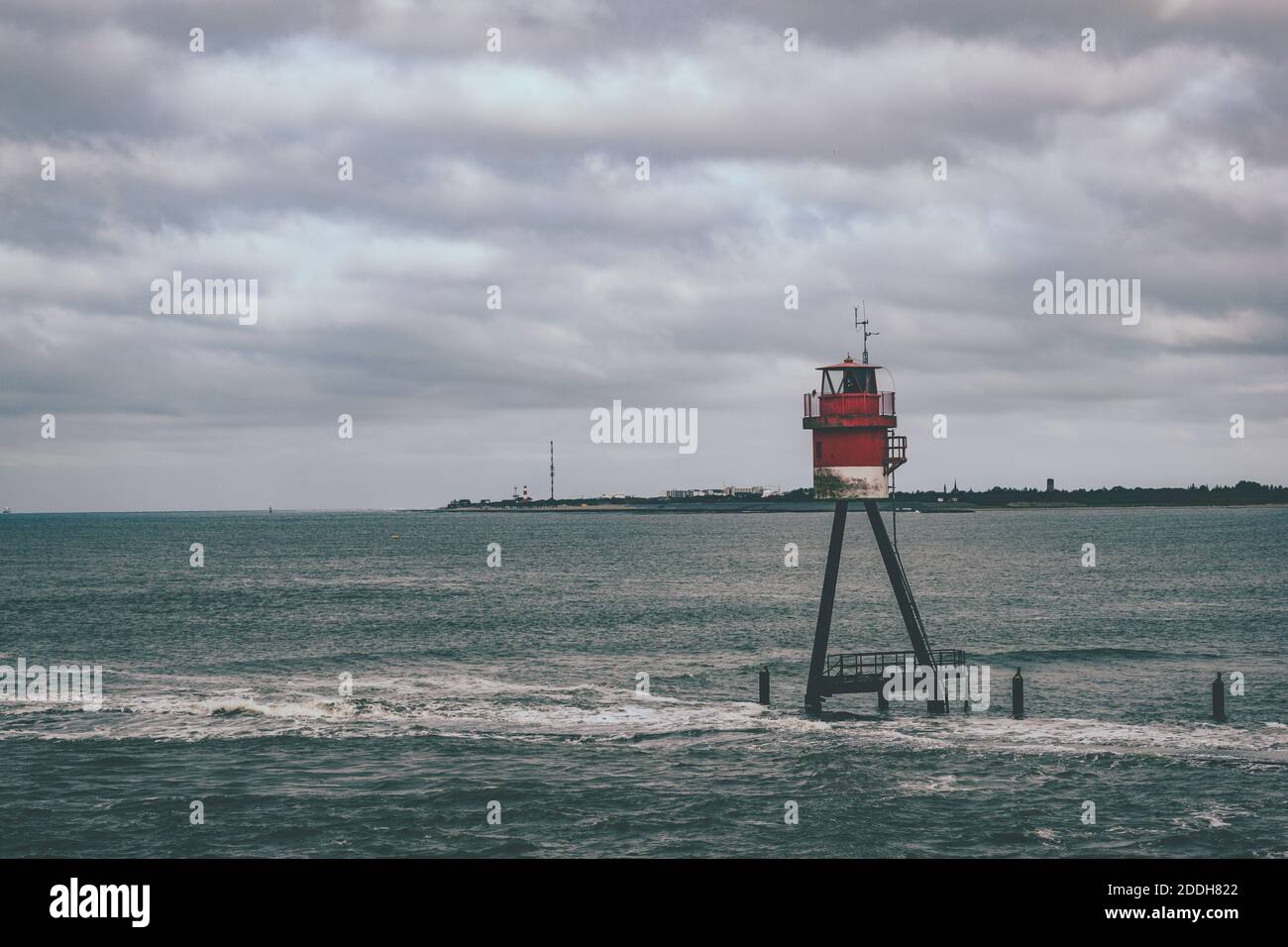 A view of a watchtower at the sea under the cloudy sky in Borkum ...