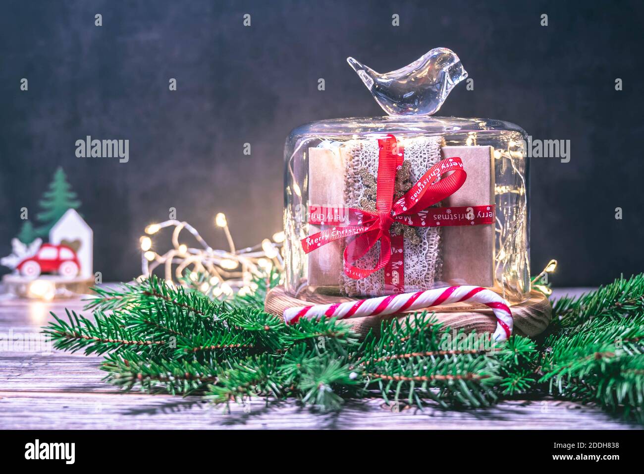 Christmas gift box in a glass cloche bell jar and christmas lights ...