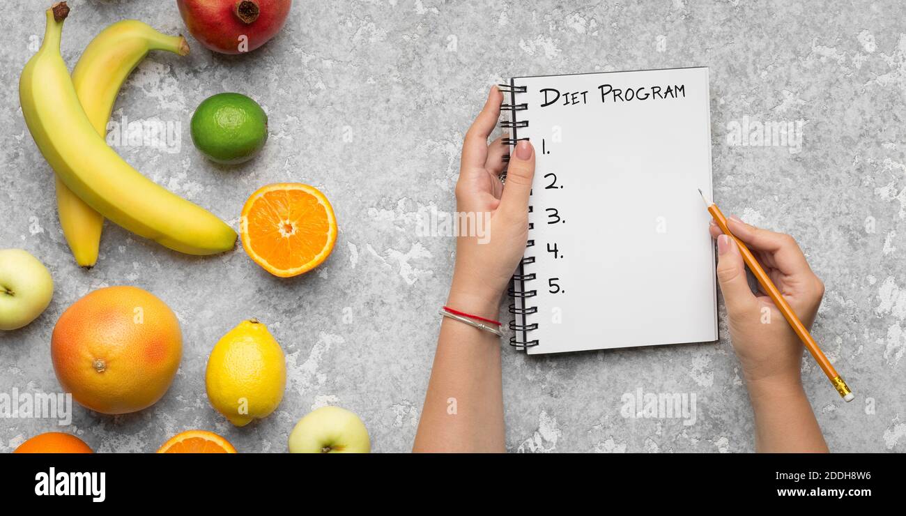 Diet Program. Female hand writing healthy nutrition plan list in ...