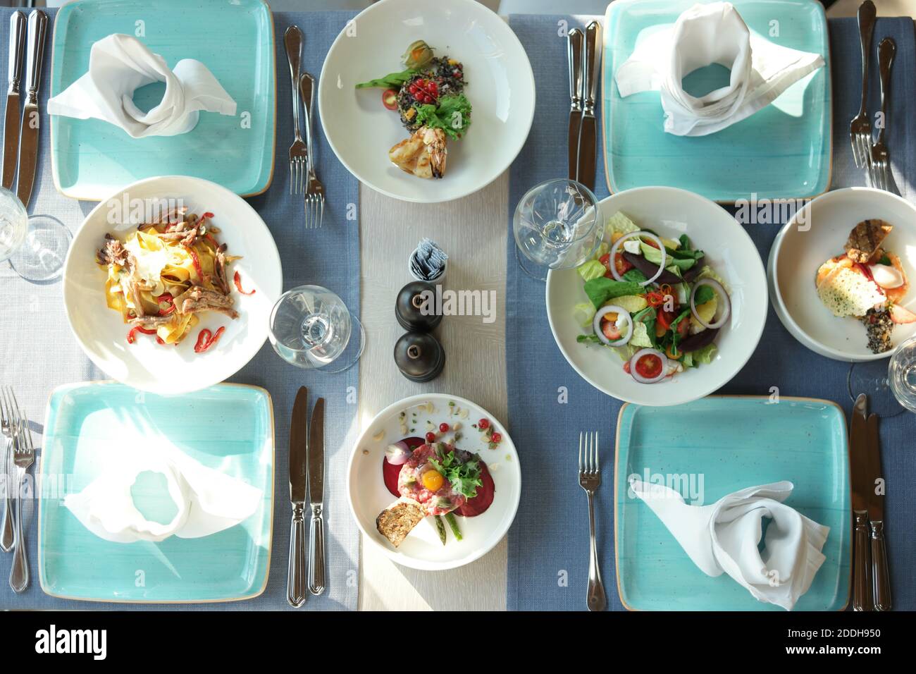 Restaurant table with food. Cold appetizers and salads on serving table ...