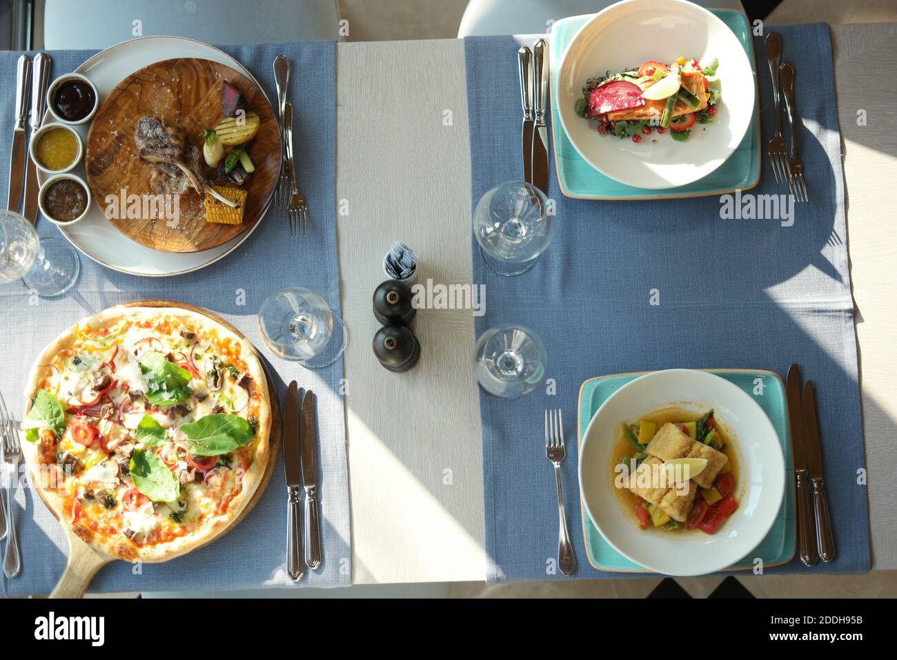 Top view of restaurant table with food. Tasty appetizers, salads and ...