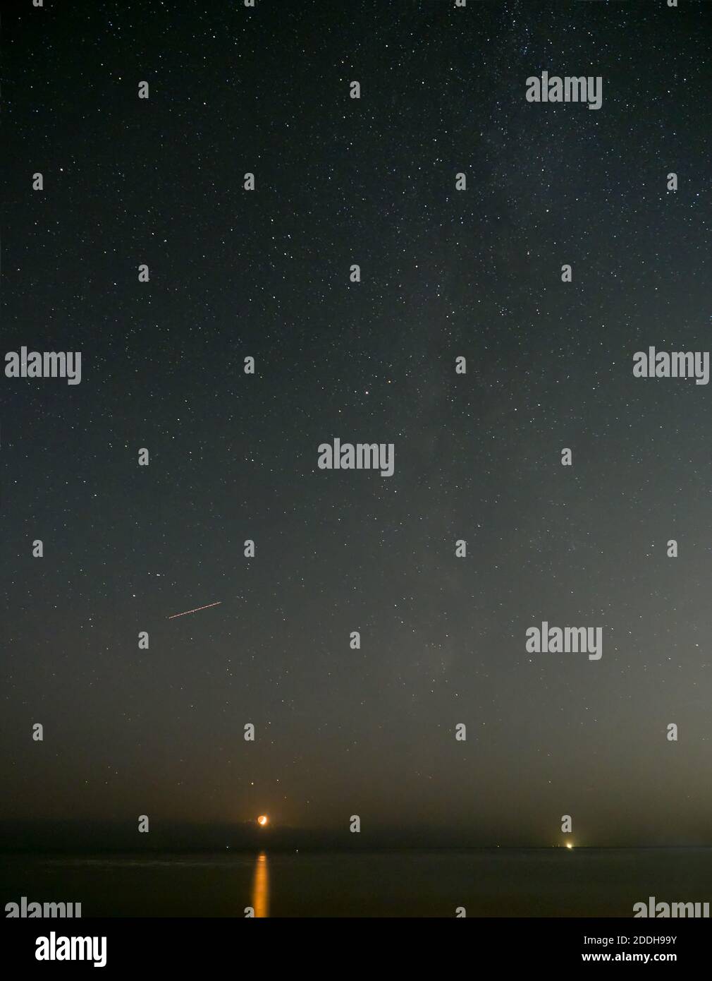 Moon setting over English Channel with faint Milky Way Stock Photo - Alamy