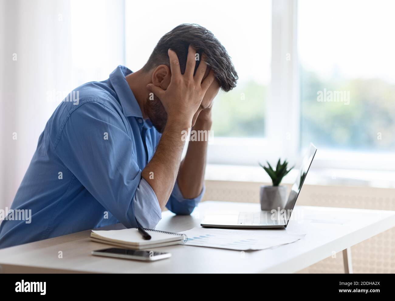 Sad entrepreneur sitting office desk hi-res stock photography and ...