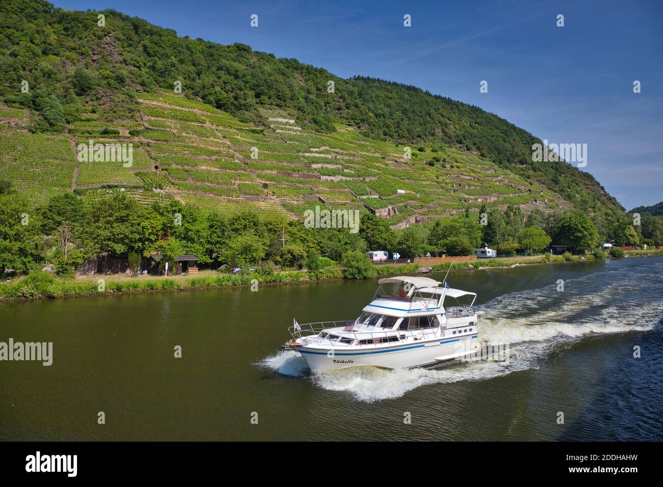 A motor yacht sailing on a stretch of the River Rhine in Germany, to a ...