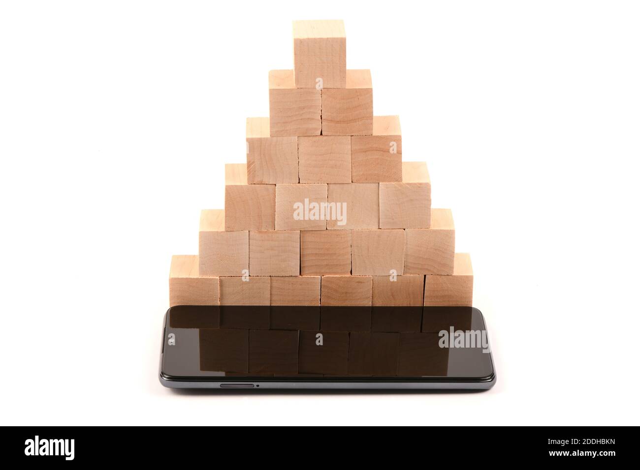 Piramid of wooden cubes on black mobile smartphone. Smartphone with ...