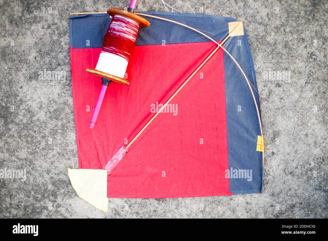 Top down flatlay shot with red and black paper and wood kite with a ...