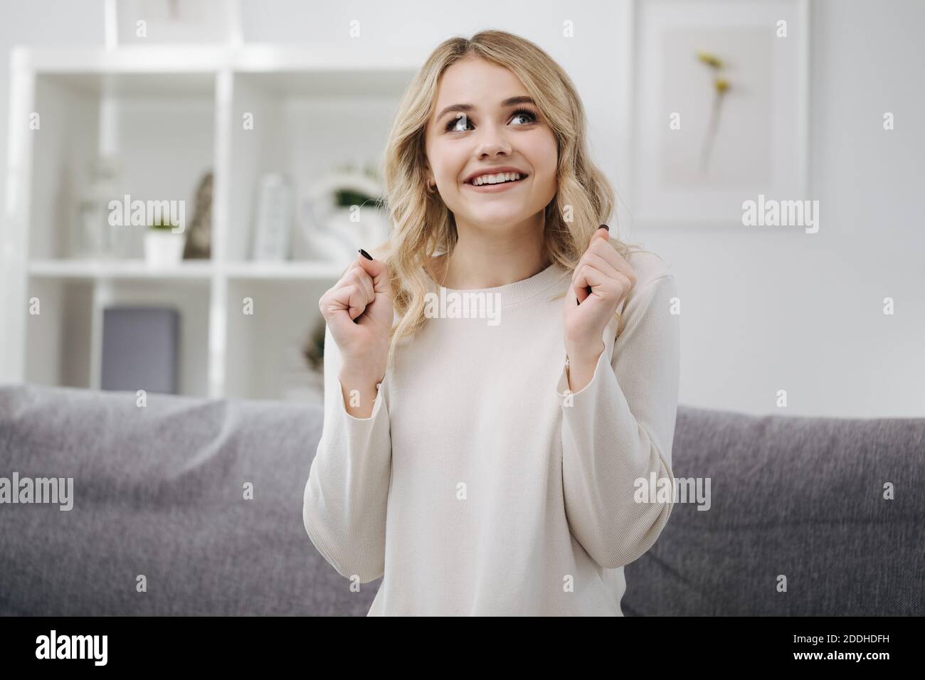 Excited woman on couch hi-res stock photography and images - Alamy