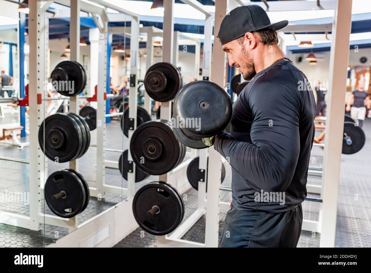 Bodybuilder trains biceps with dumbels. Fitness and crossfit concept ...