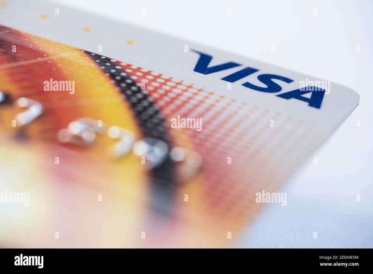 Close-up of a Visa credit card placed on a light background. Focus on ...