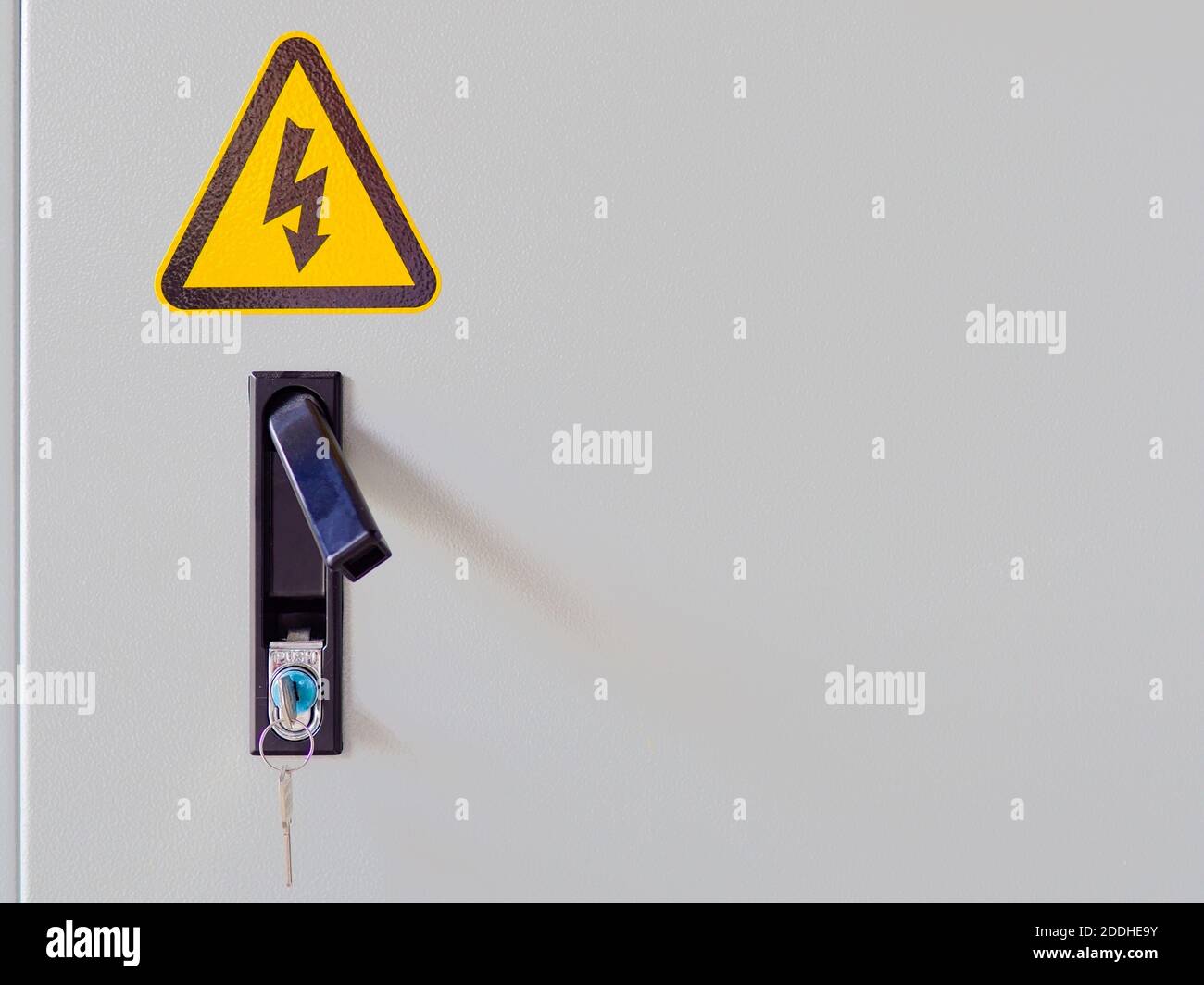 A closeup of electrocution hazard icon sticker on power panel door ...