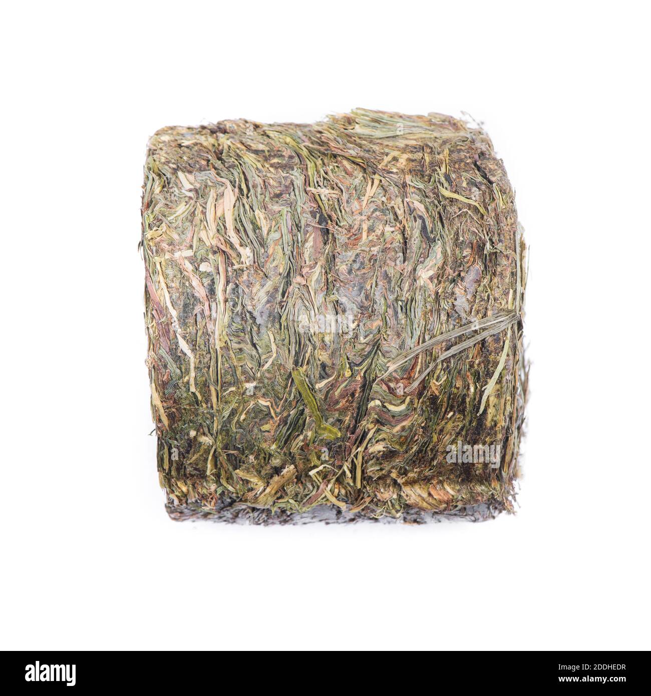 Pressed grass, hay in small cylinder isolated over white background ...