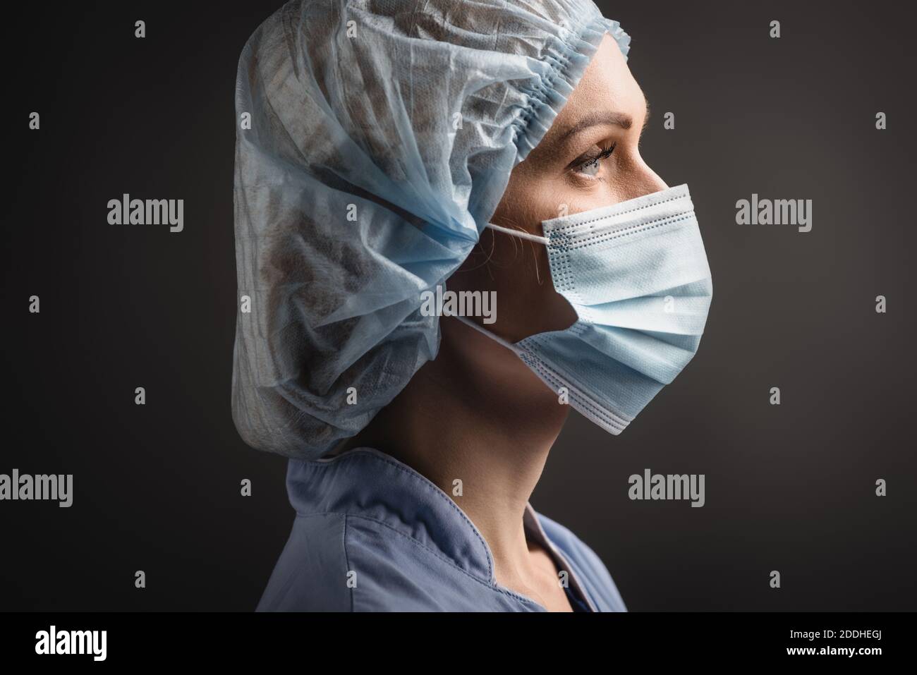 side view of nurse in medical cap and mask looking away isolated on ...