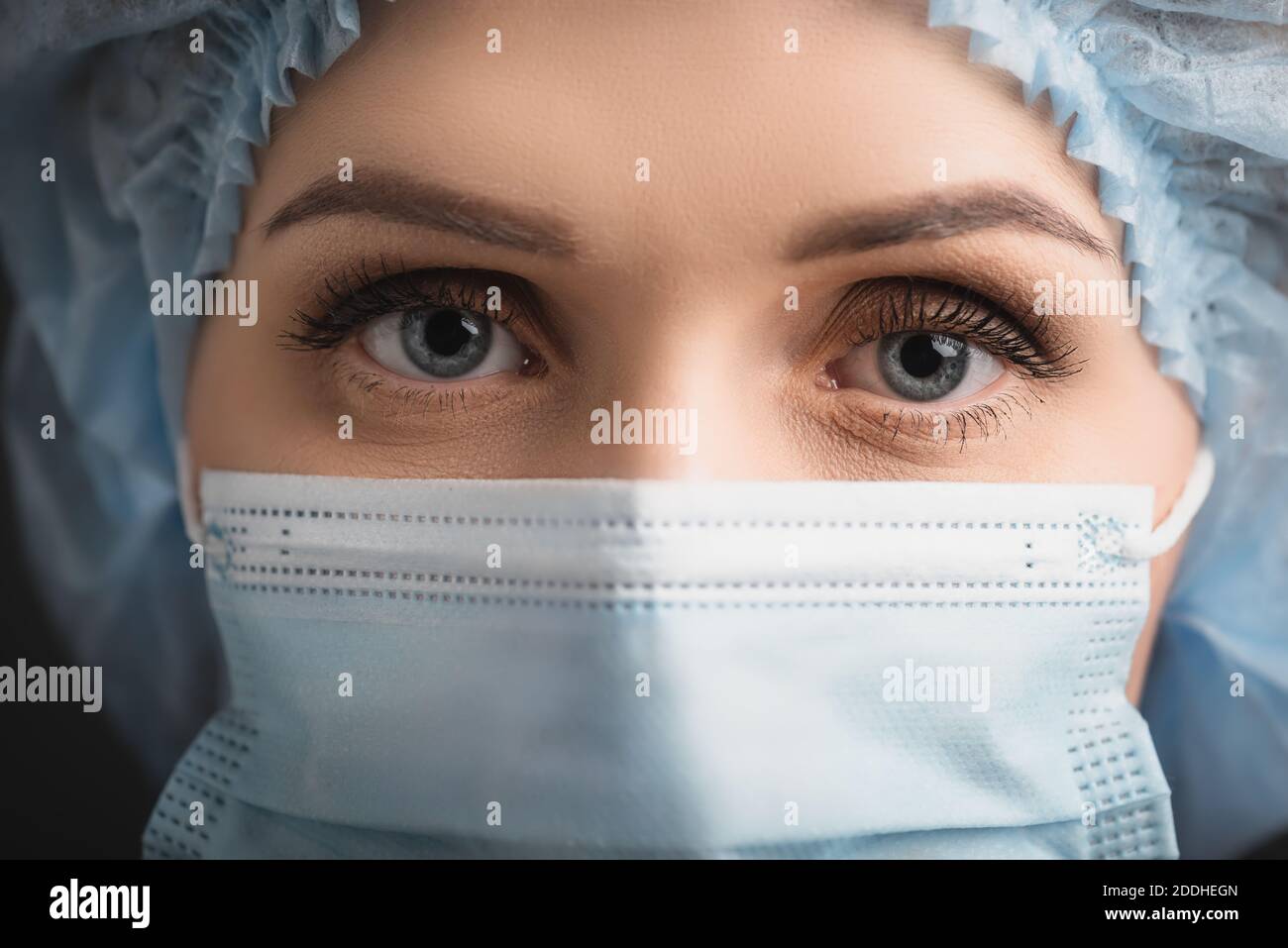 close up of nurse in medical cap and mask looking at camera Stock Photo ...