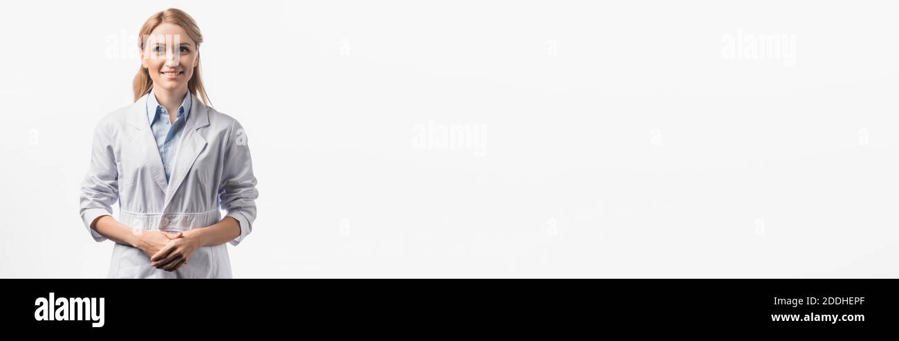 happy nurse in white coat standing with clenched hands isolated on ...