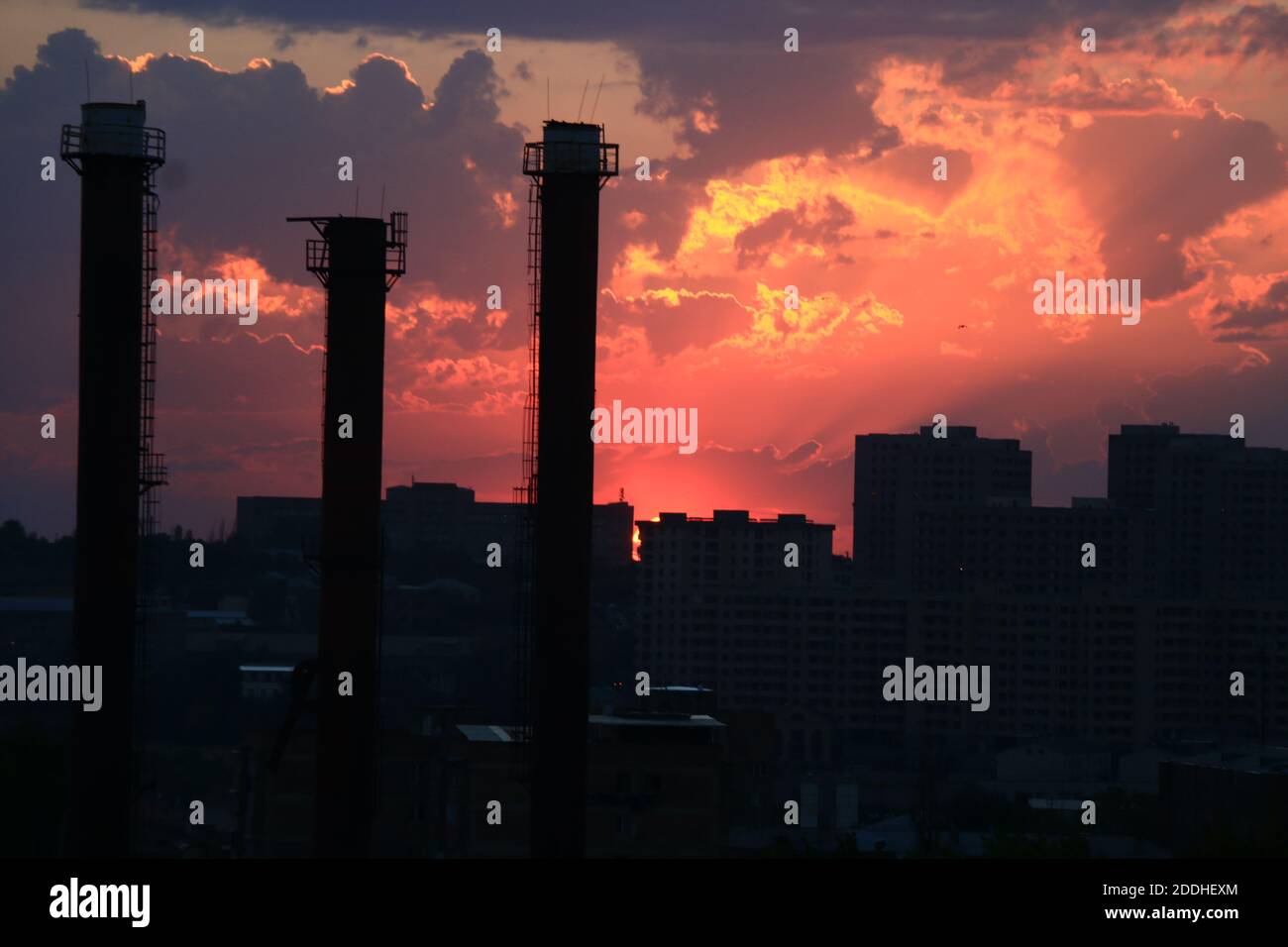 A mesmerizing sunset sky against the silhouettes of the buildings Stock ...