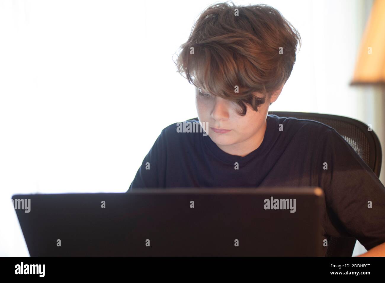 teen boy school student watching online webinar learn on laptop sit in ...