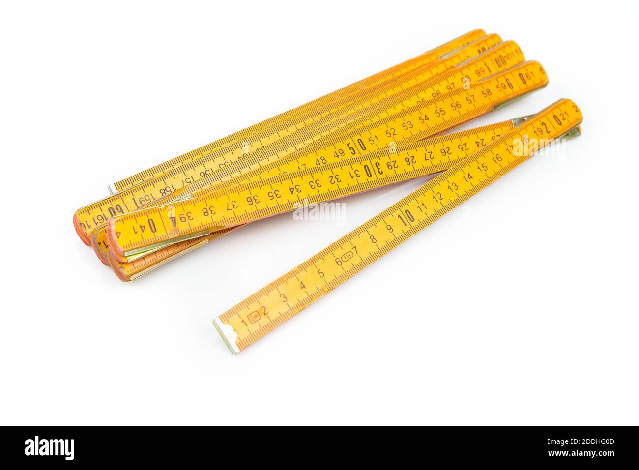 A yellow foldable measuring tape on a white background Stock Photo - Alamy