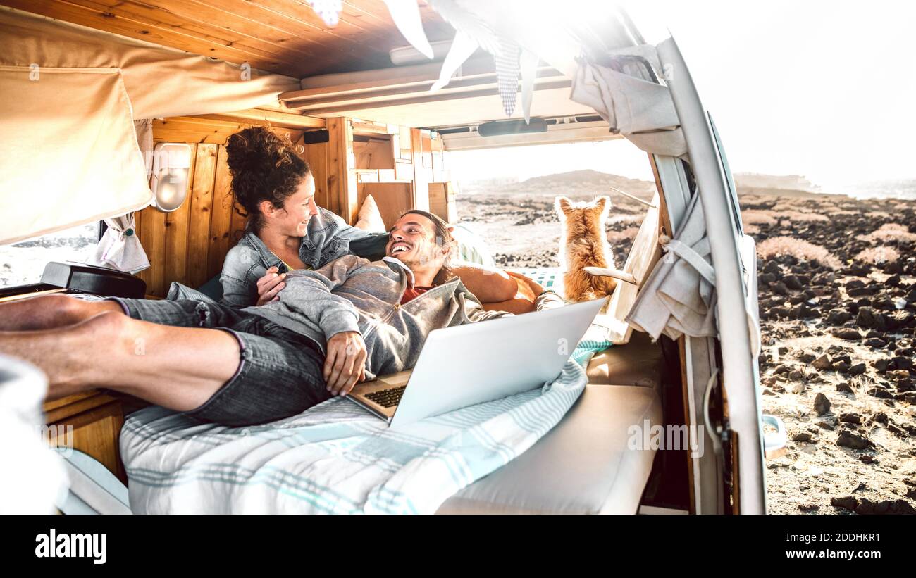 Hipster couple with dog traveling together on retro mini van transport ...