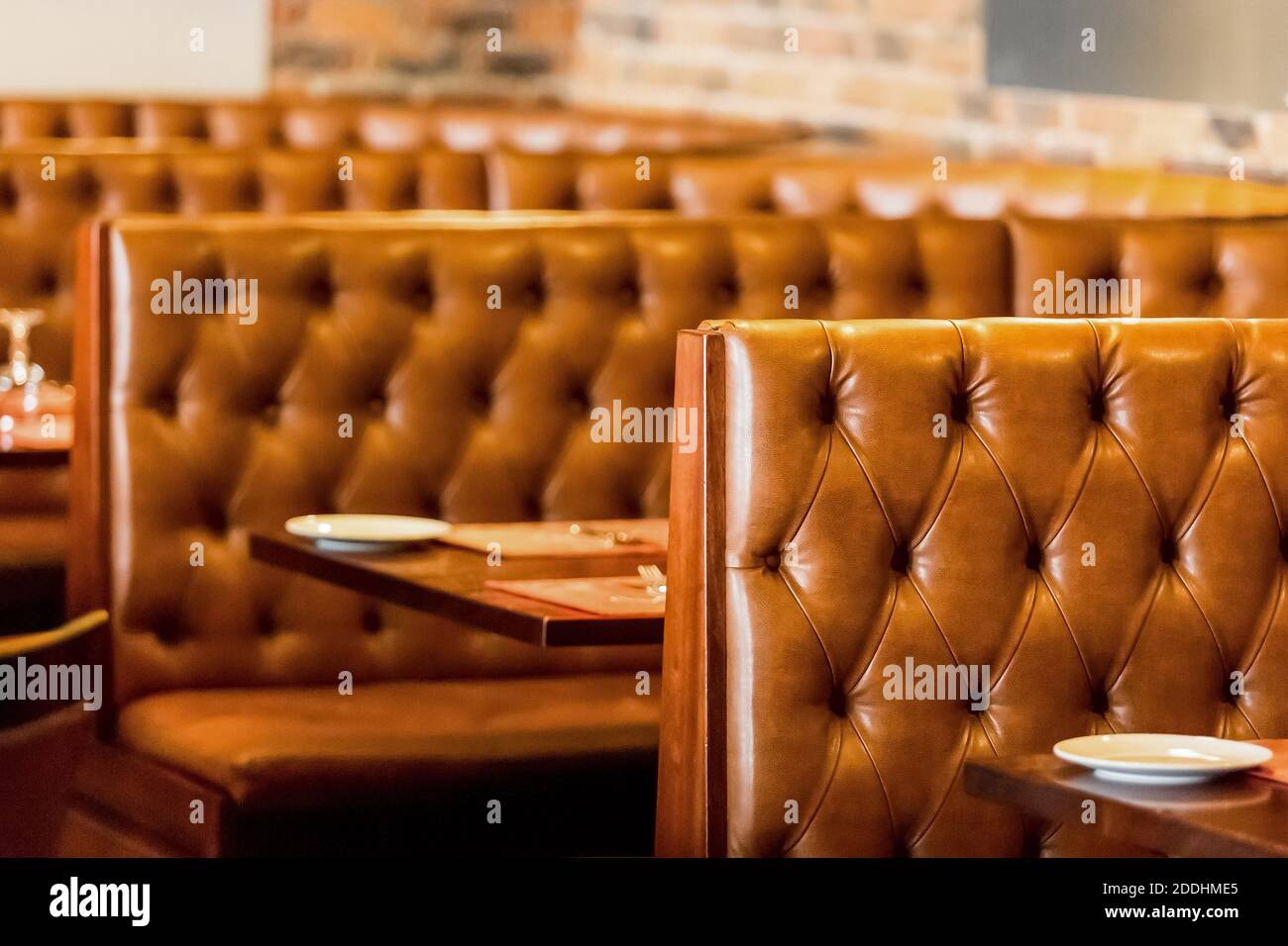 The inside of a restaurant with empty leather chairs and tables Stock ...