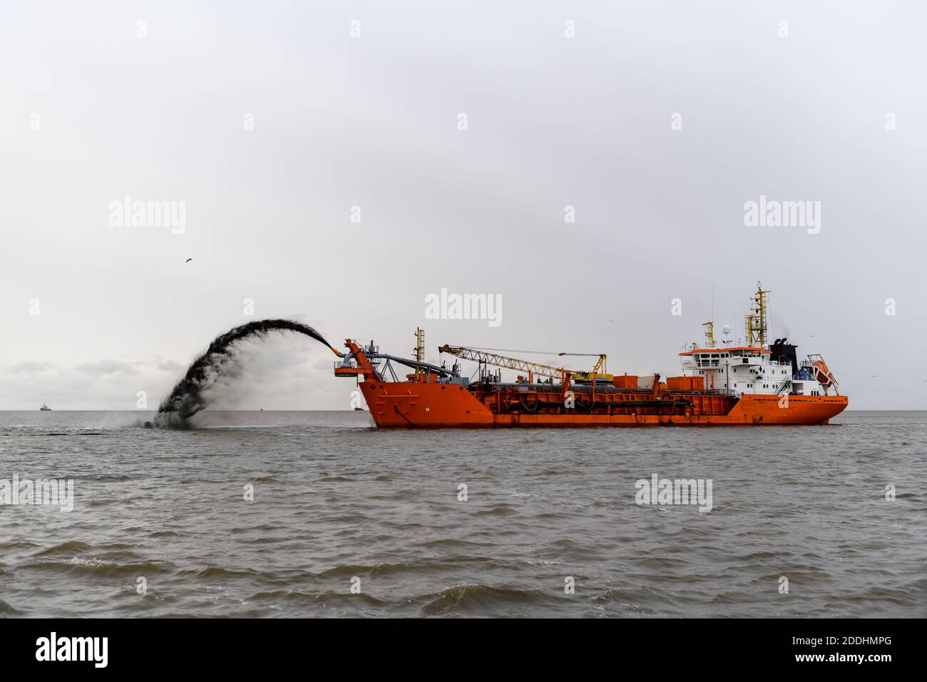 Vessel engaged in dredging. Dredger working at sea. Ship excavating ...
