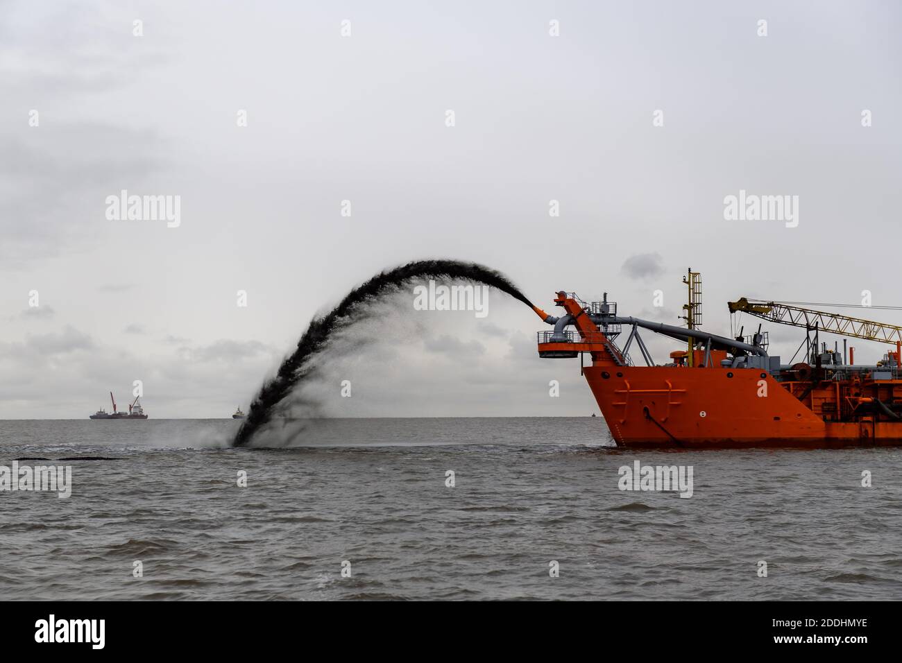 Vessel engaged in dredging. Dredger working at sea. Ship excavating ...