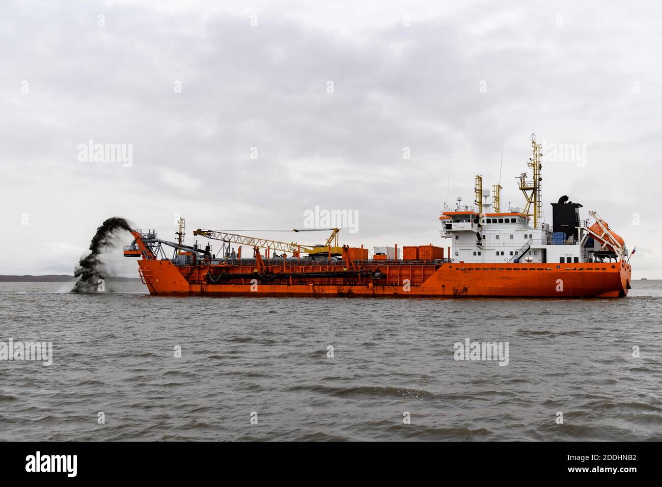 Vessel engaged in dredging. Dredger working at sea. Ship excavating ...