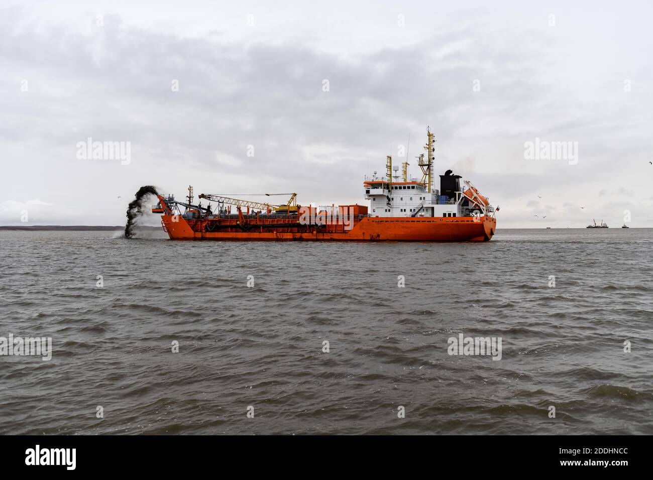 Vessel engaged in dredging. Dredger working at sea. Ship excavating ...