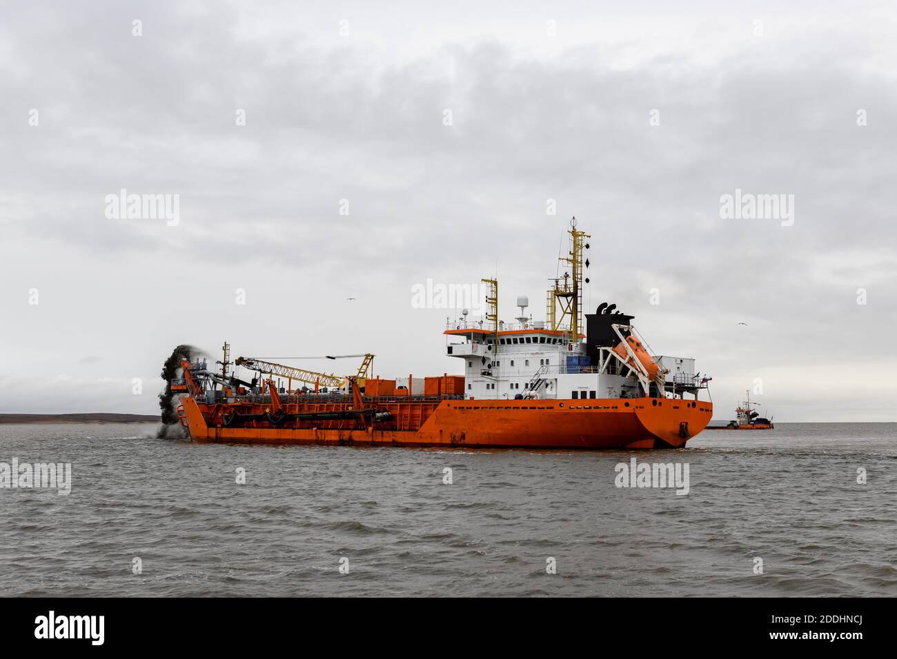 Vessel engaged in dredging. Dredger working at sea. Ship excavating ...