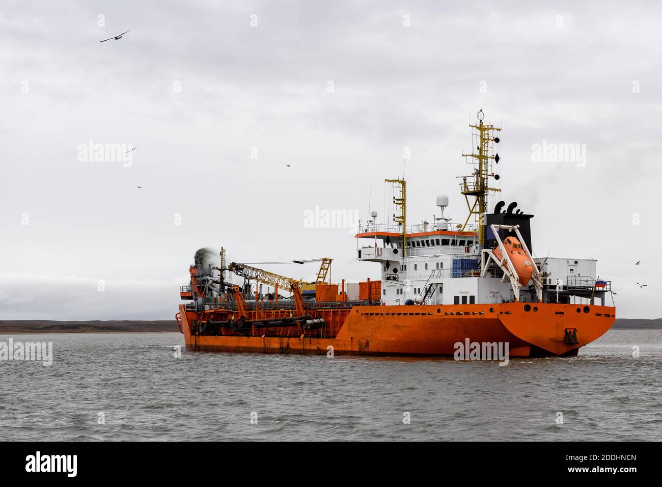 Vessel engaged in dredging. Dredger working at sea. Ship excavating ...