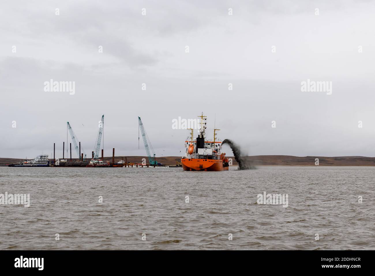 Vessel engaged in dredging. Dredger working at sea. Ship excavating ...
