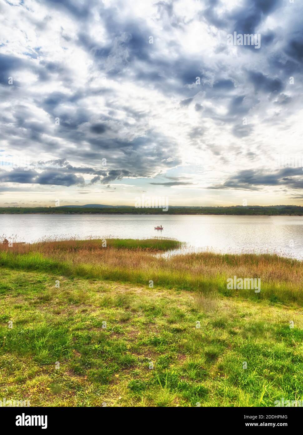 Vertical landscape with a shore and a lake and line of horizon ...