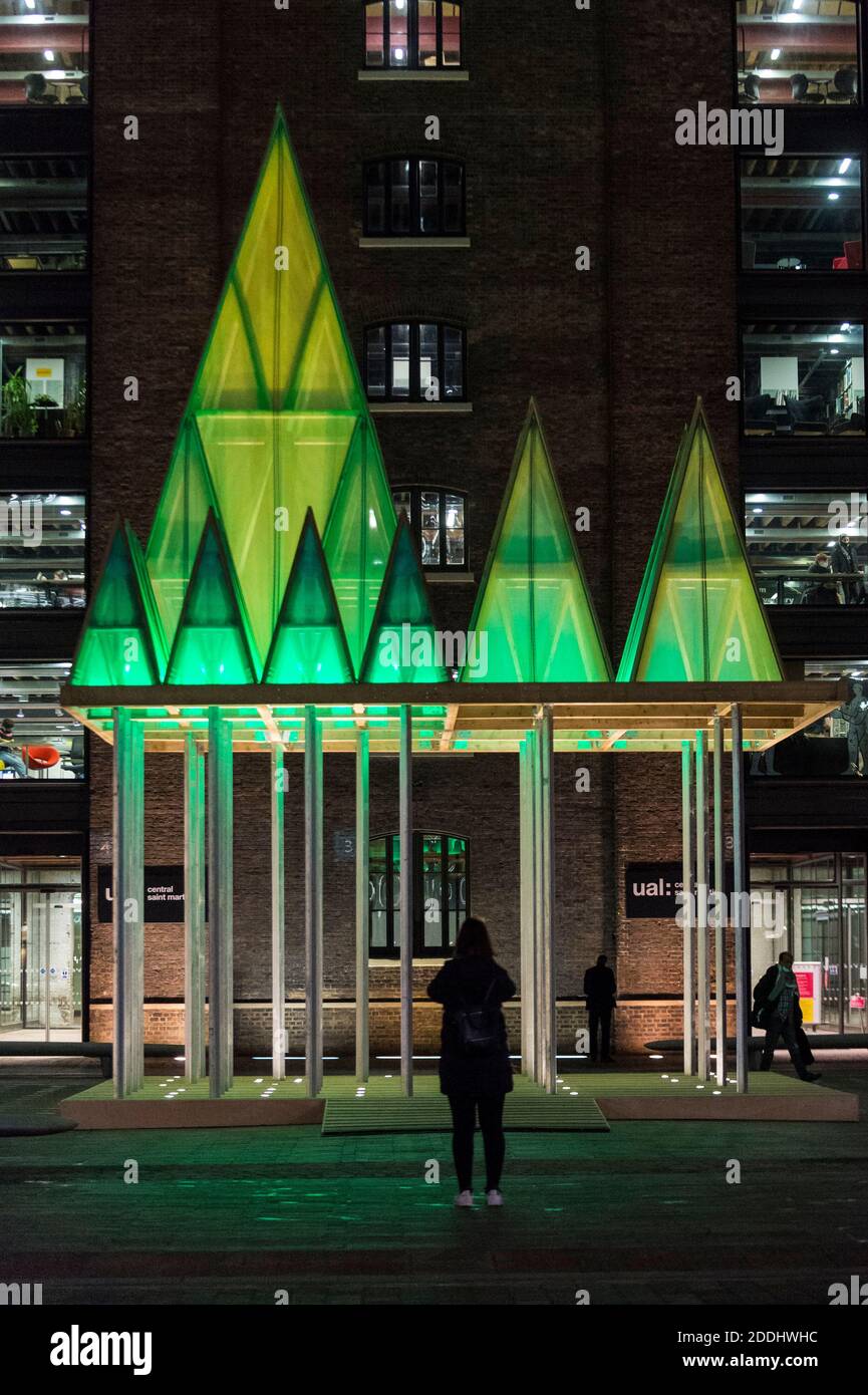 London, UK. 25 November 2020. A visitor views The Electric Nemeton Tree ...