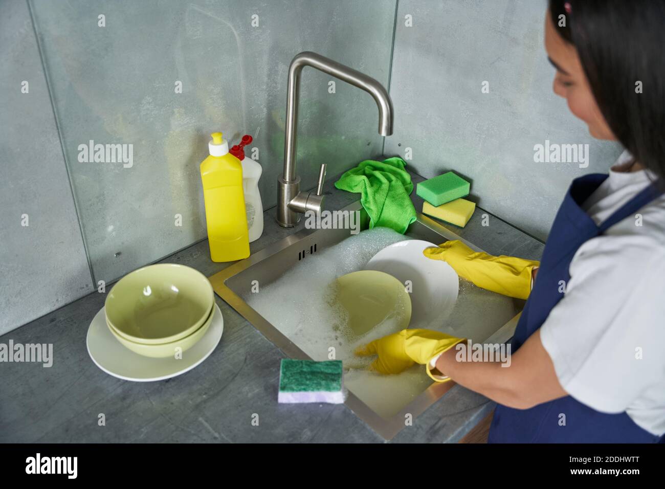 Lady washing utensil hi-res stock photography and images - Alamy