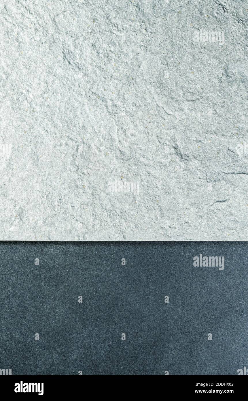 A closeup of a bright and dark-toned textured rough stone background ...