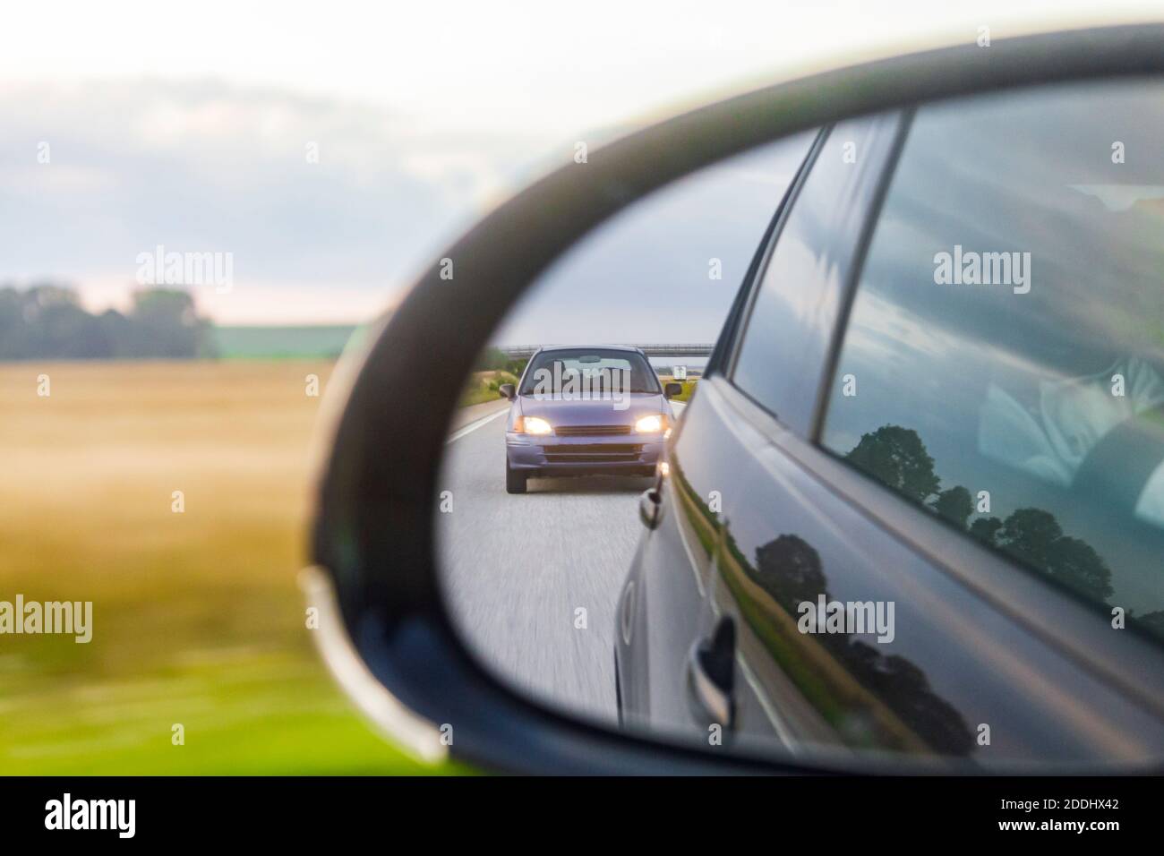 Purple car in the rearview mirror on the highway in Malmö Sweden Stock ...