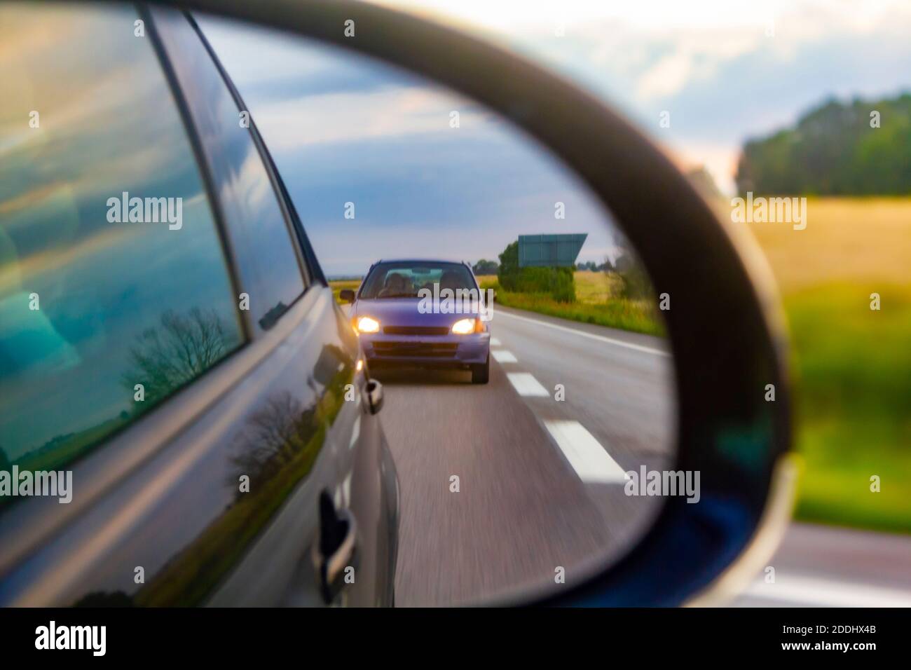 Purple car in the rearview mirror on the highway in Malmö Sweden Stock ...