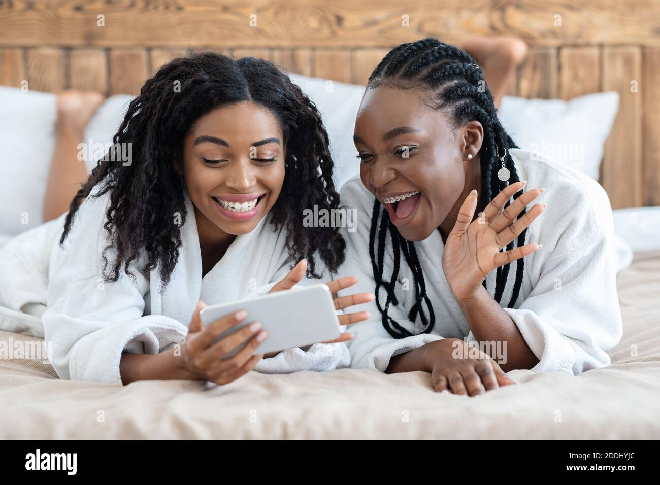 Happy african american women calling their girlfriend Stock Photo - Alamy